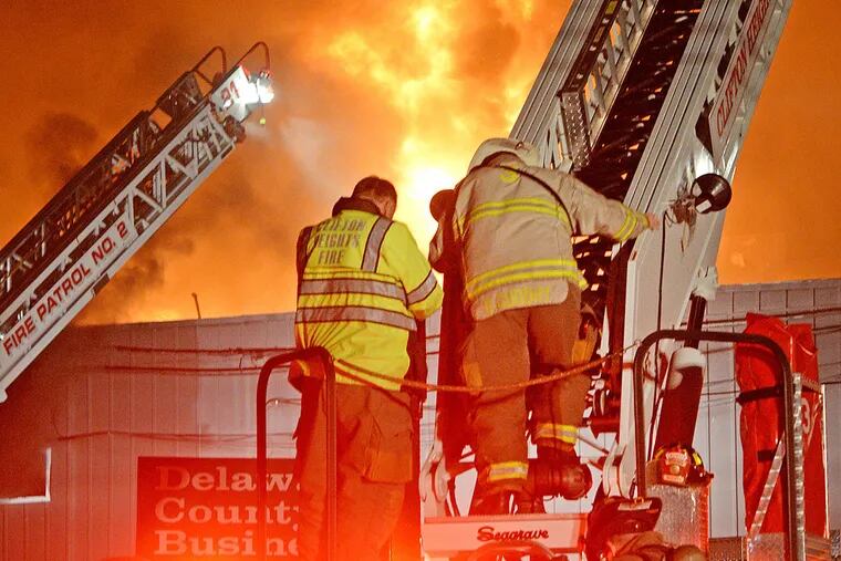 Delco fire destroys 20 vehicles and building