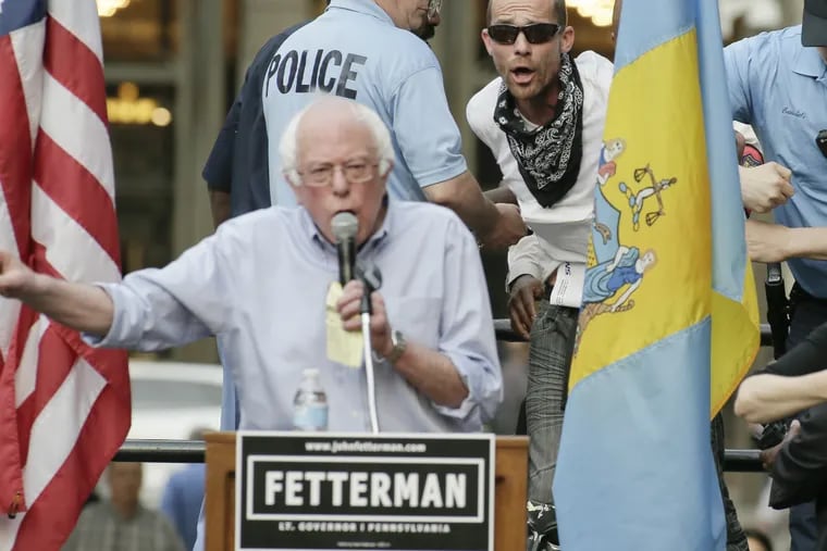 Protester detained by police at City Hall as Bernie Sanders stumps for ...