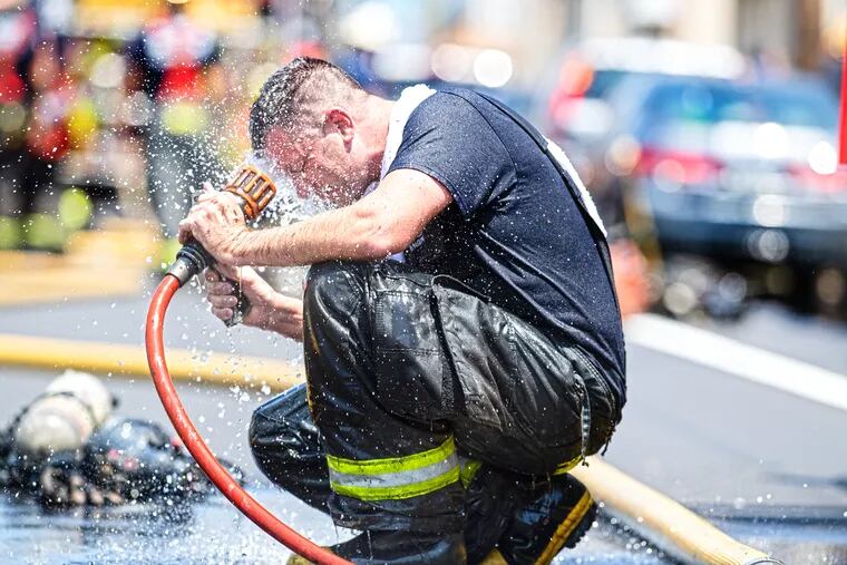 Firefighter cools off after a long day in the sun