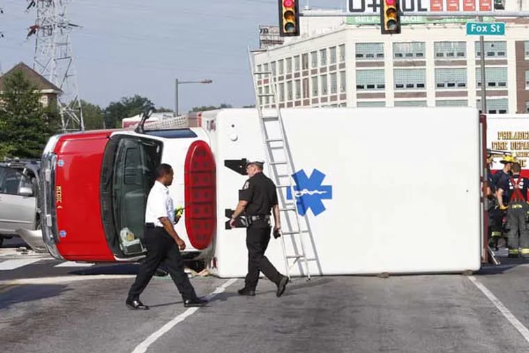 Ambulance flips on side in crash